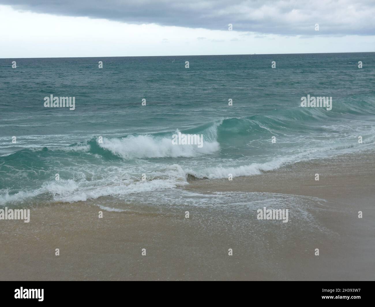 Waves crashing Onto Beach Stock Photo - Alamy