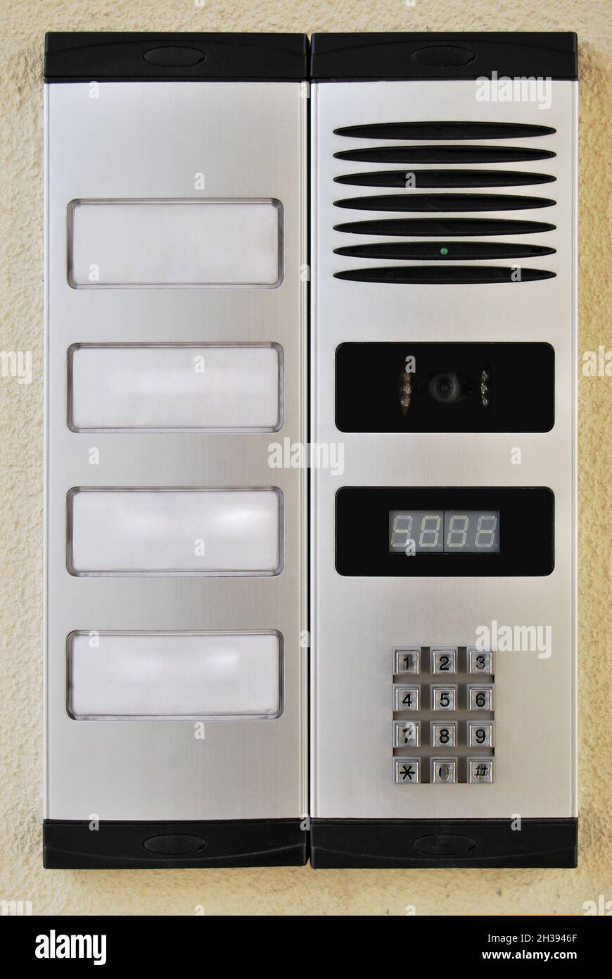 Modern video intercom hanging on the wall at the entrance of the ...