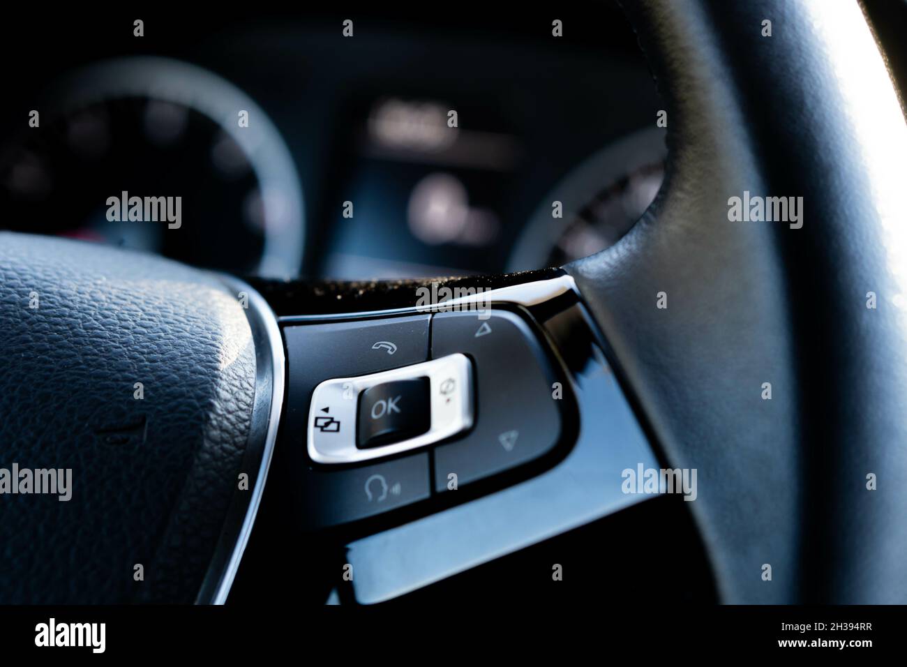 Close-up shot of a steering wheel with buttons for different functions ...