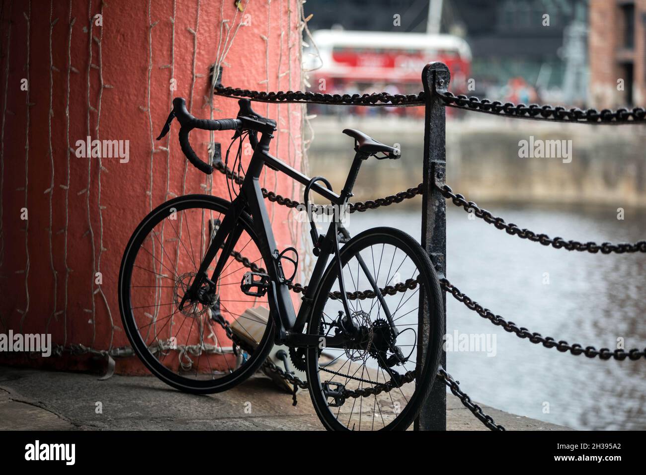 A bike chained to railings at Albert Dock, Liverpool Stock Photo - Alamy