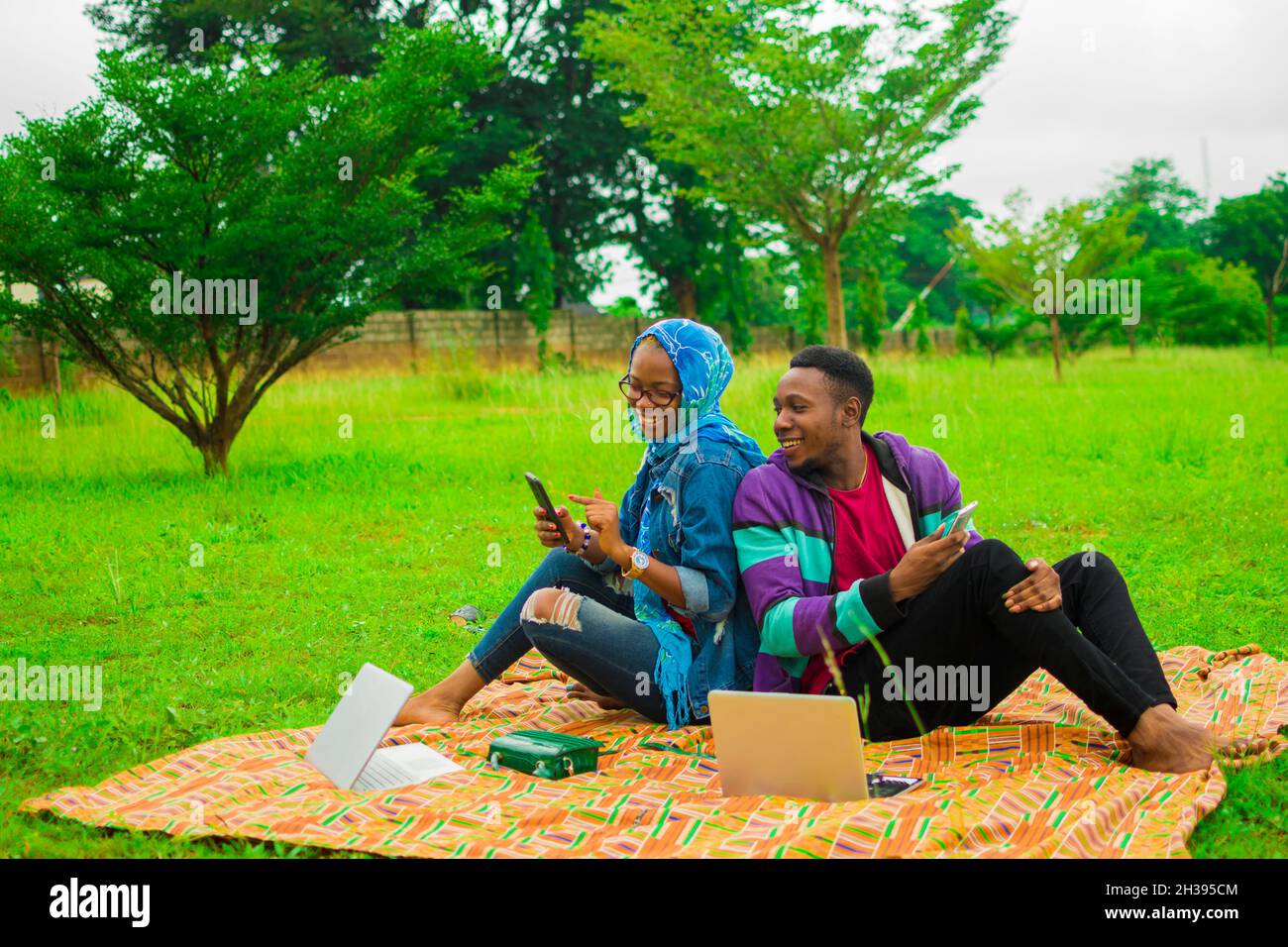 happy good african friends having fun outdoors with mobile phone ...