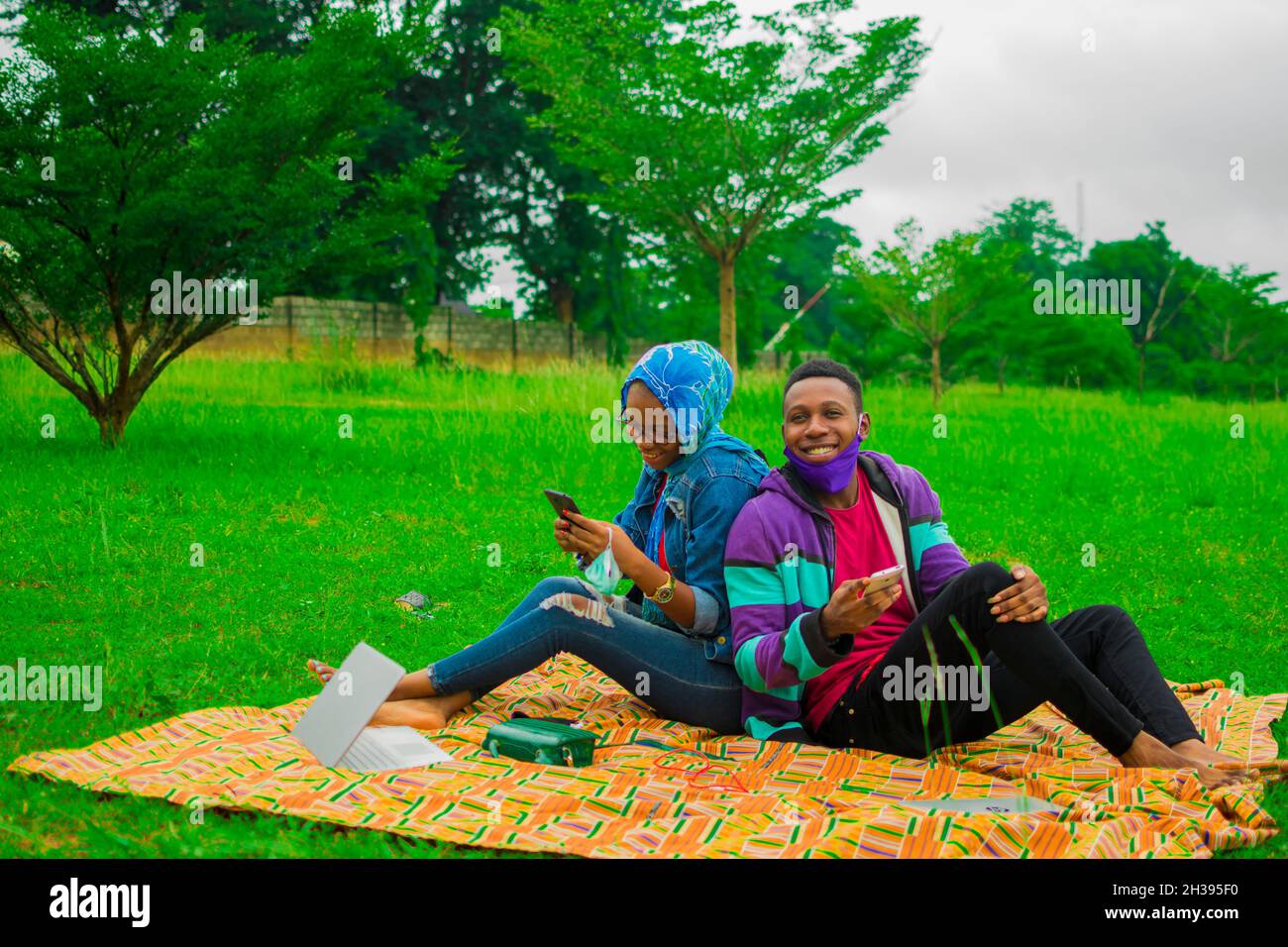 happy good african friends having fun outdoors with mobile phone ...