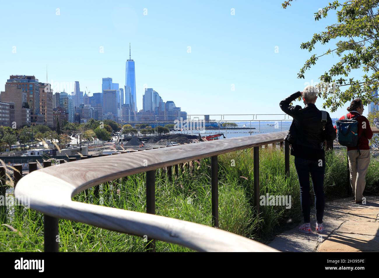 Visitors on Little Island at Pier 55 with Lower Manhattan skyline and ...