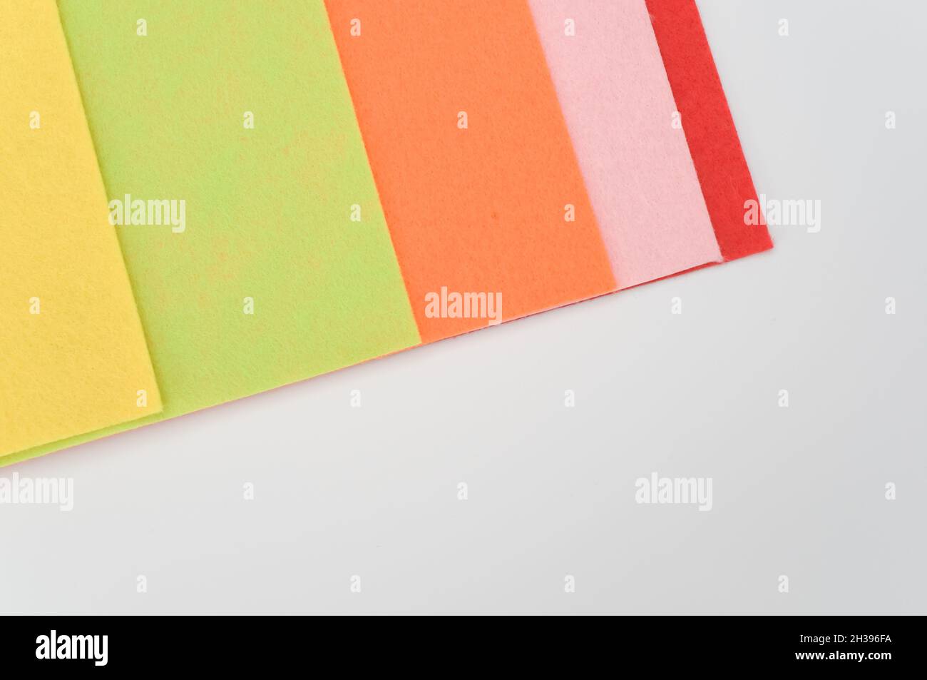 multicolored felt sheets backdrop on white background Stock Photo - Alamy