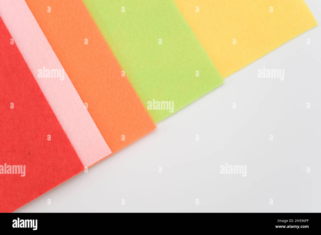 multicolored felt sheets backdrop on white background Stock Photo - Alamy