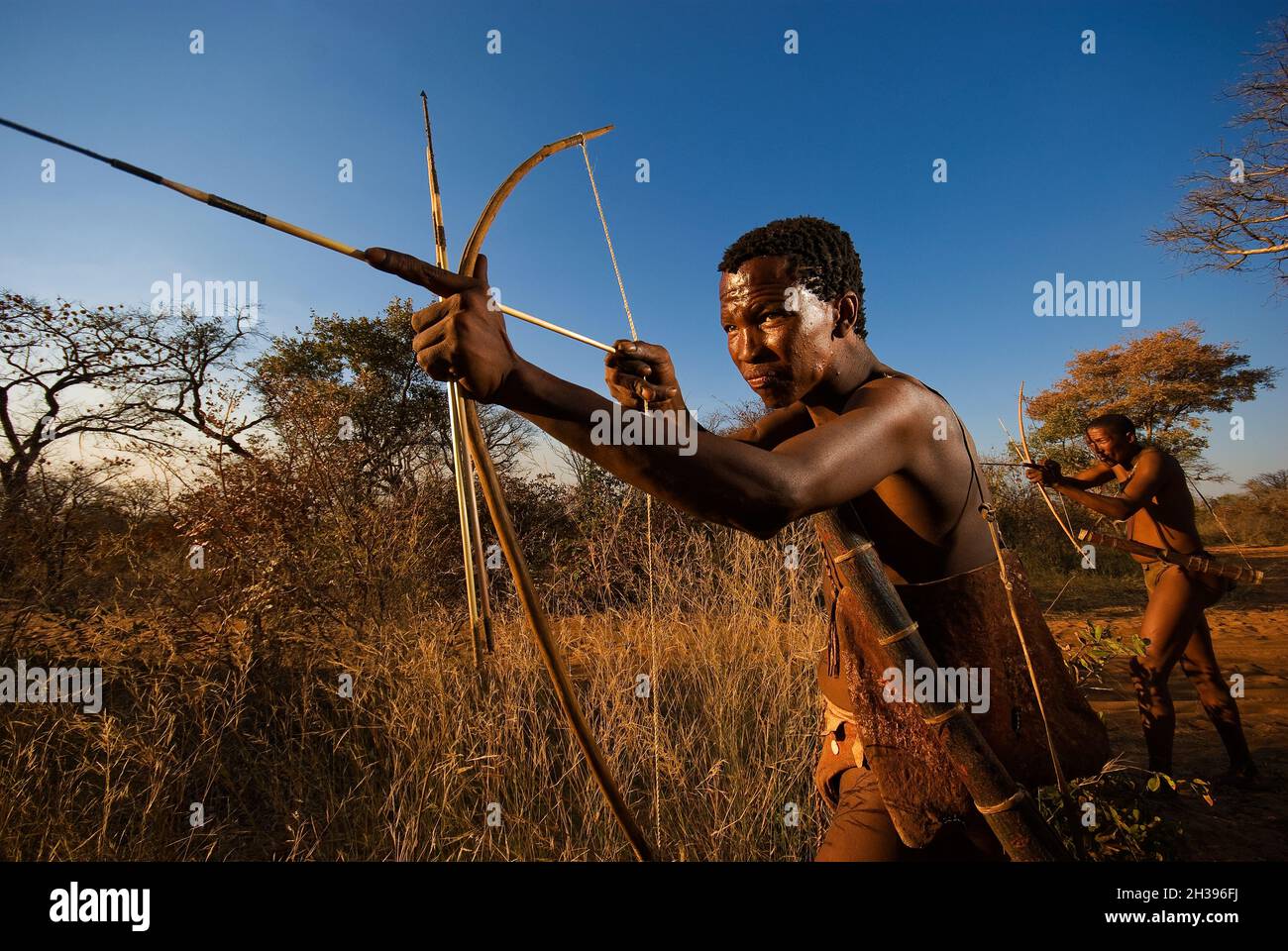 Bushman men simulating a hunt at Grashoek, Namibia Stock Photo - Alamy