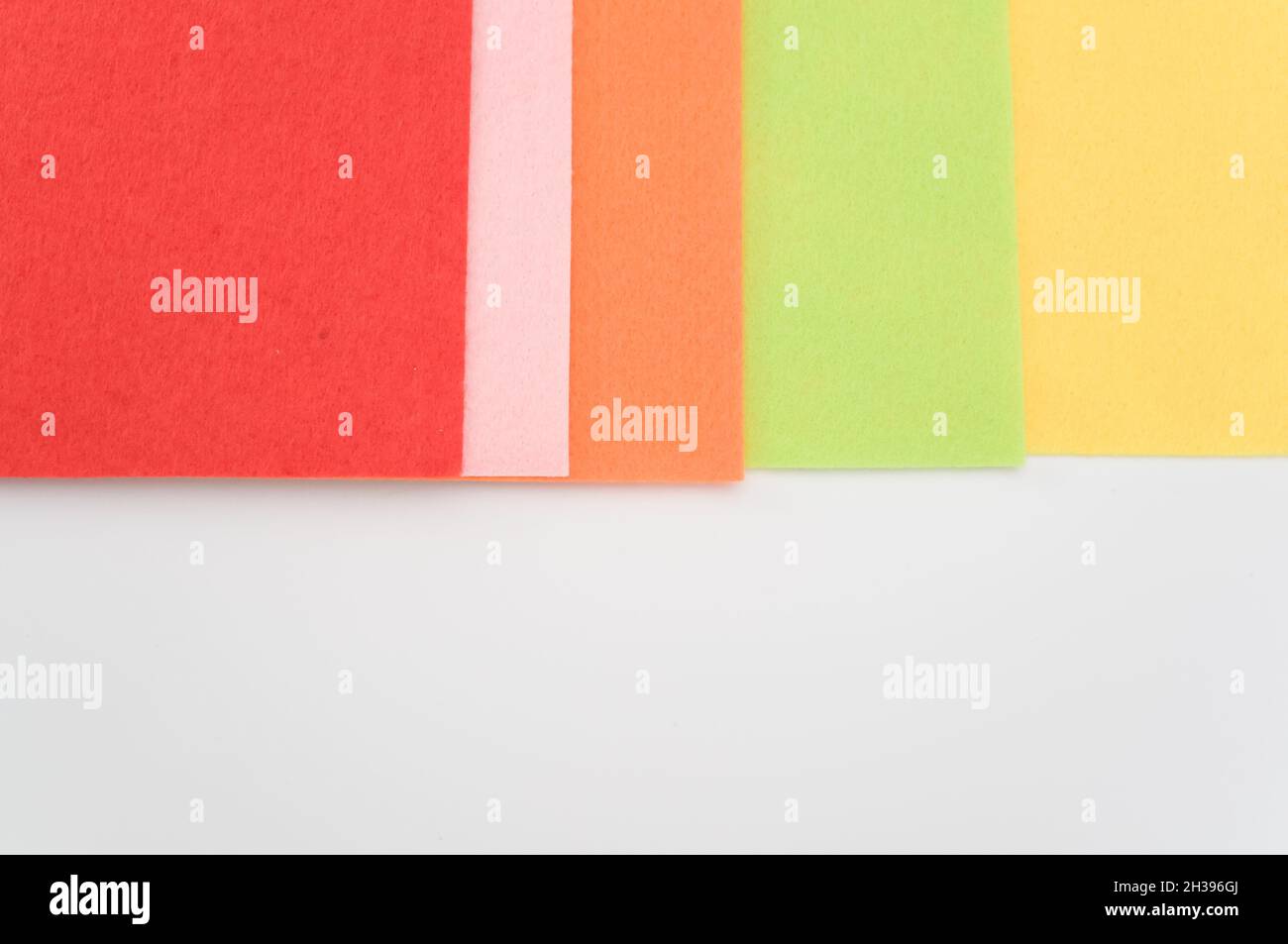 multicolored felt sheets backdrop on white background Stock Photo - Alamy