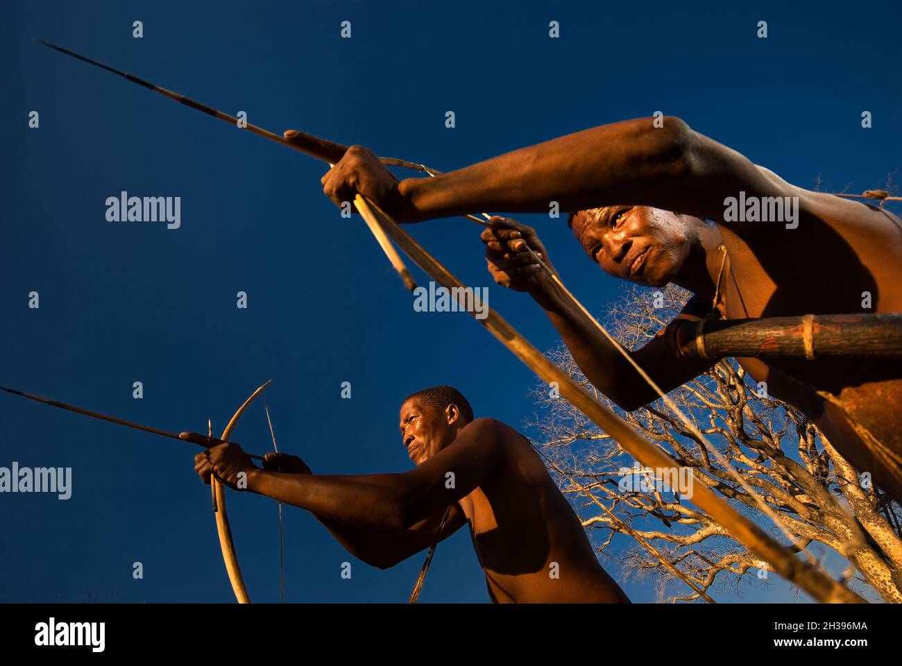 Bushman men simulating a hunt at Grashoek, Namibia Stock Photo - Alamy