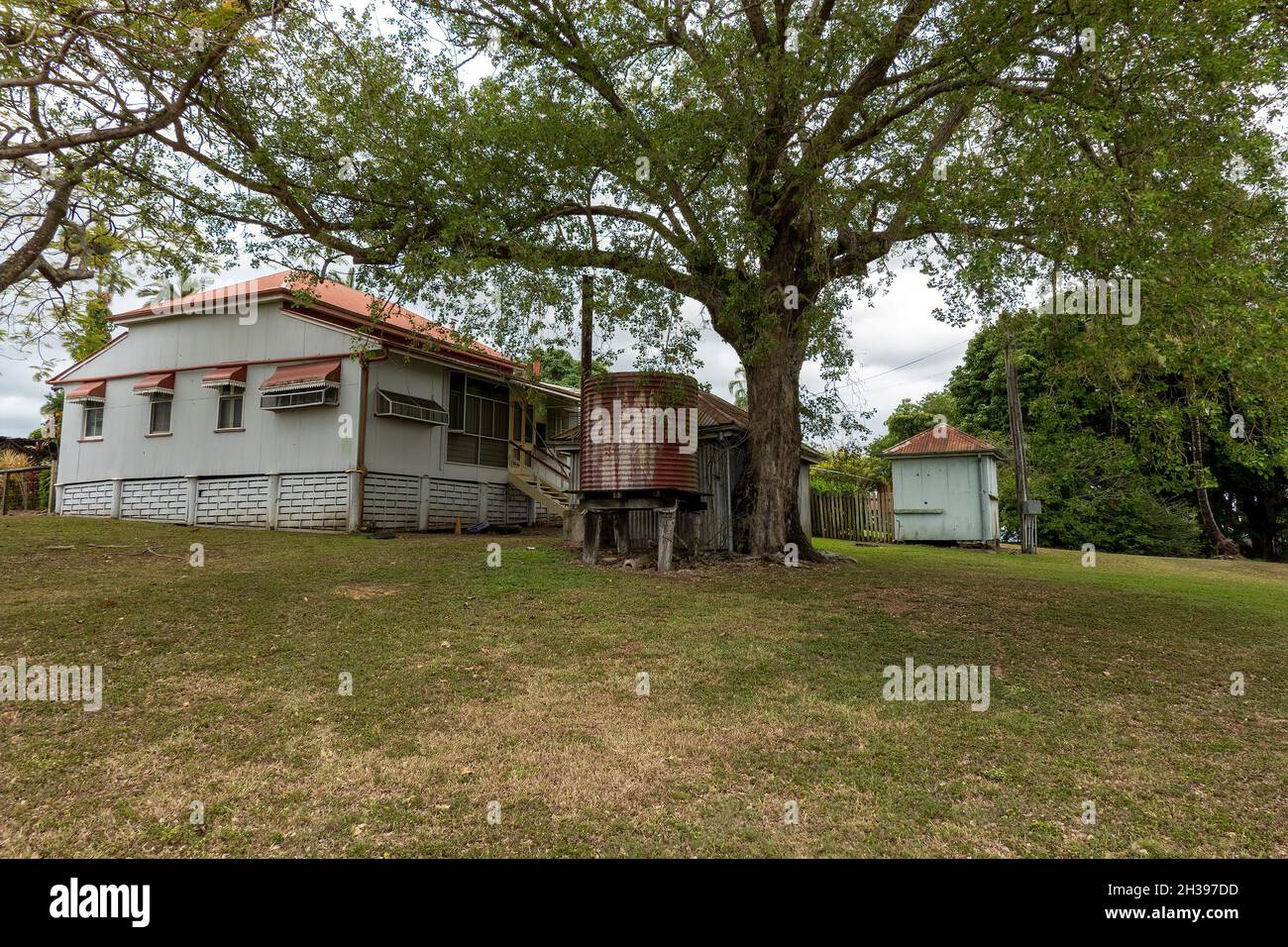 The back of an historical homestead with water tank and old wash house ...