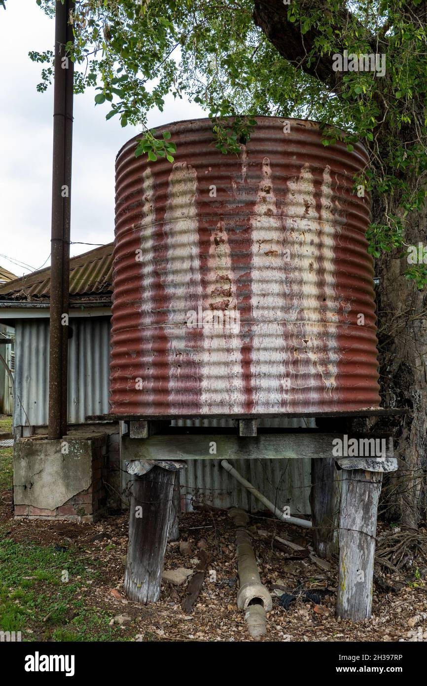 An old iron tank stand marked with the years of time, standing on ...