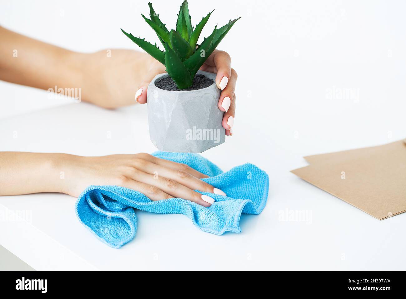 Hand of a woman wiping work desk, close-up Stock Photo - Alamy