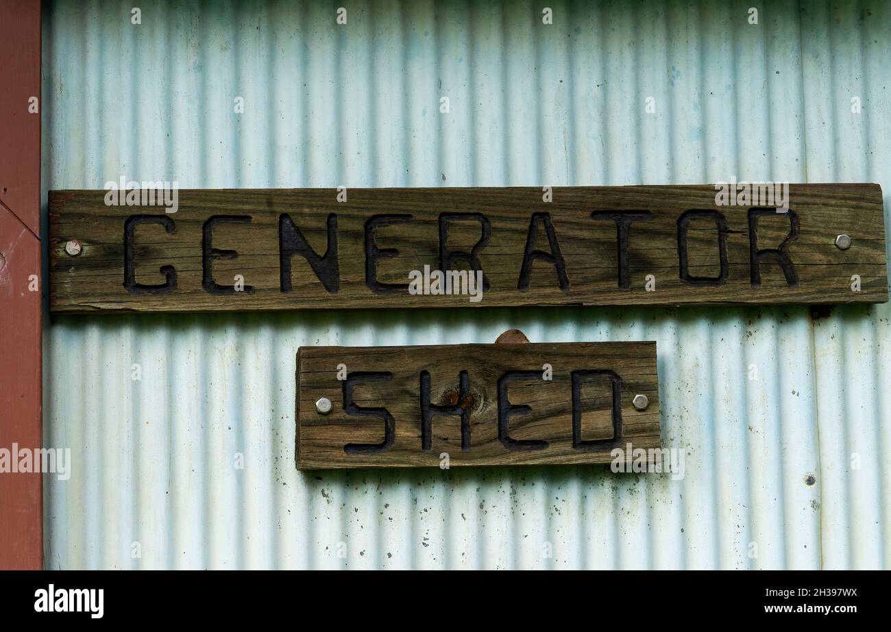 Wooden carved generator shed signage on corrugated iron wall Stock ...