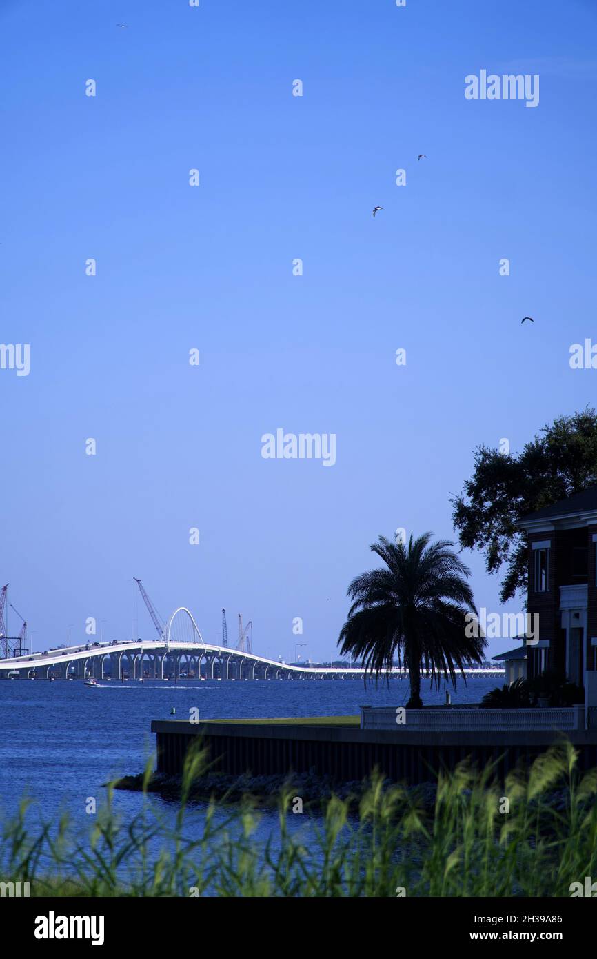 Beautiful shot of a bridge with cranes behind a coastal resort Stock ...