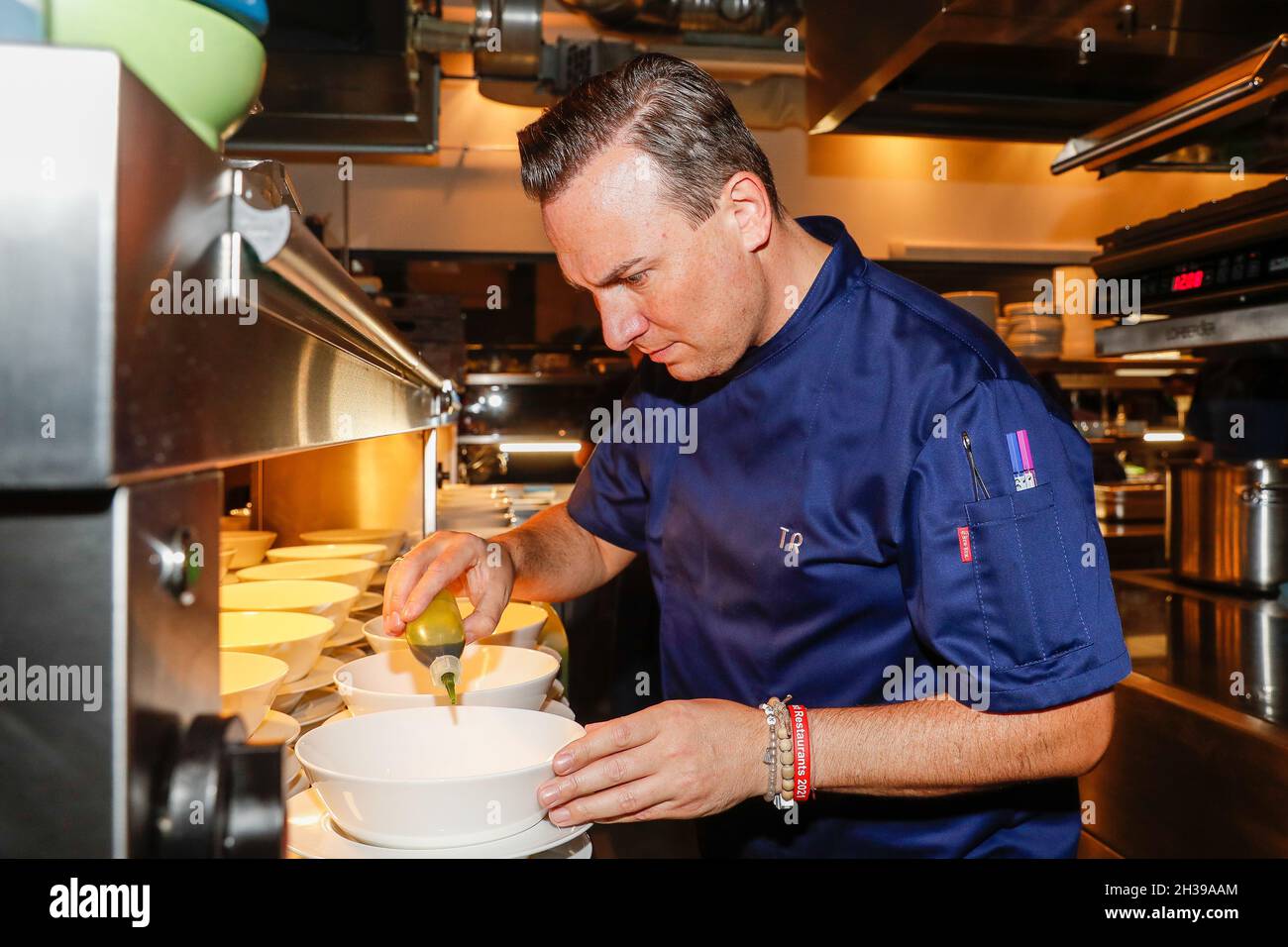 Berlin, Germany. 26th Oct, 2021. Berlin top chef Tim Raue prepares a ...