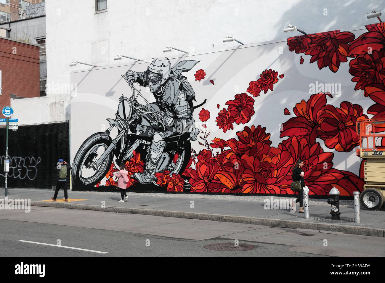 Partial view of a colorful mural of a motorcycle rider with red flowers ...