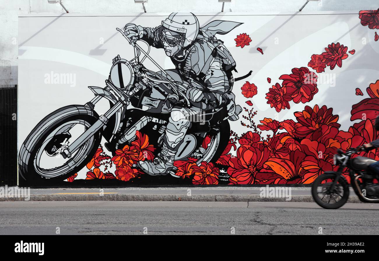 Partial view of a colorful mural of a motorcycle rider with red flowers ...