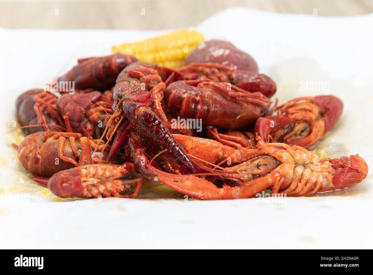 Boiled pot of a pile of crawfish seasoned perfectly and served with ...