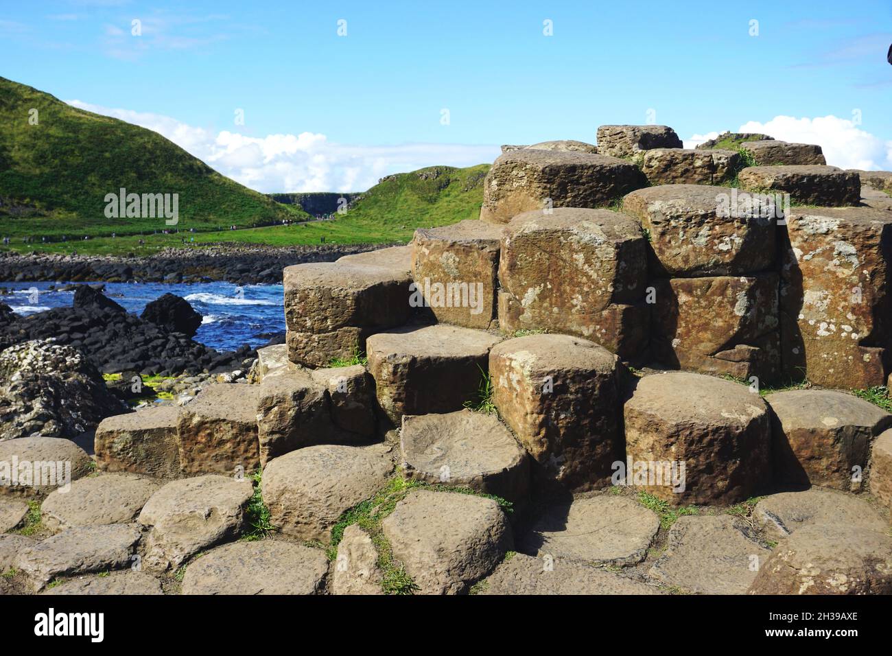 Close-up of natural volcanic basalt rock formations with the sea and ...