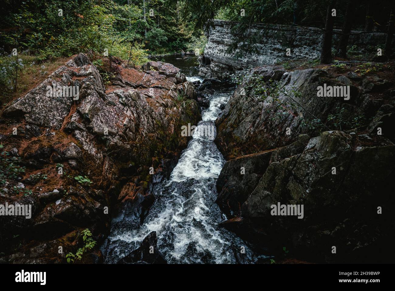 Water channel in between huge rocks Stock Photo - Alamy