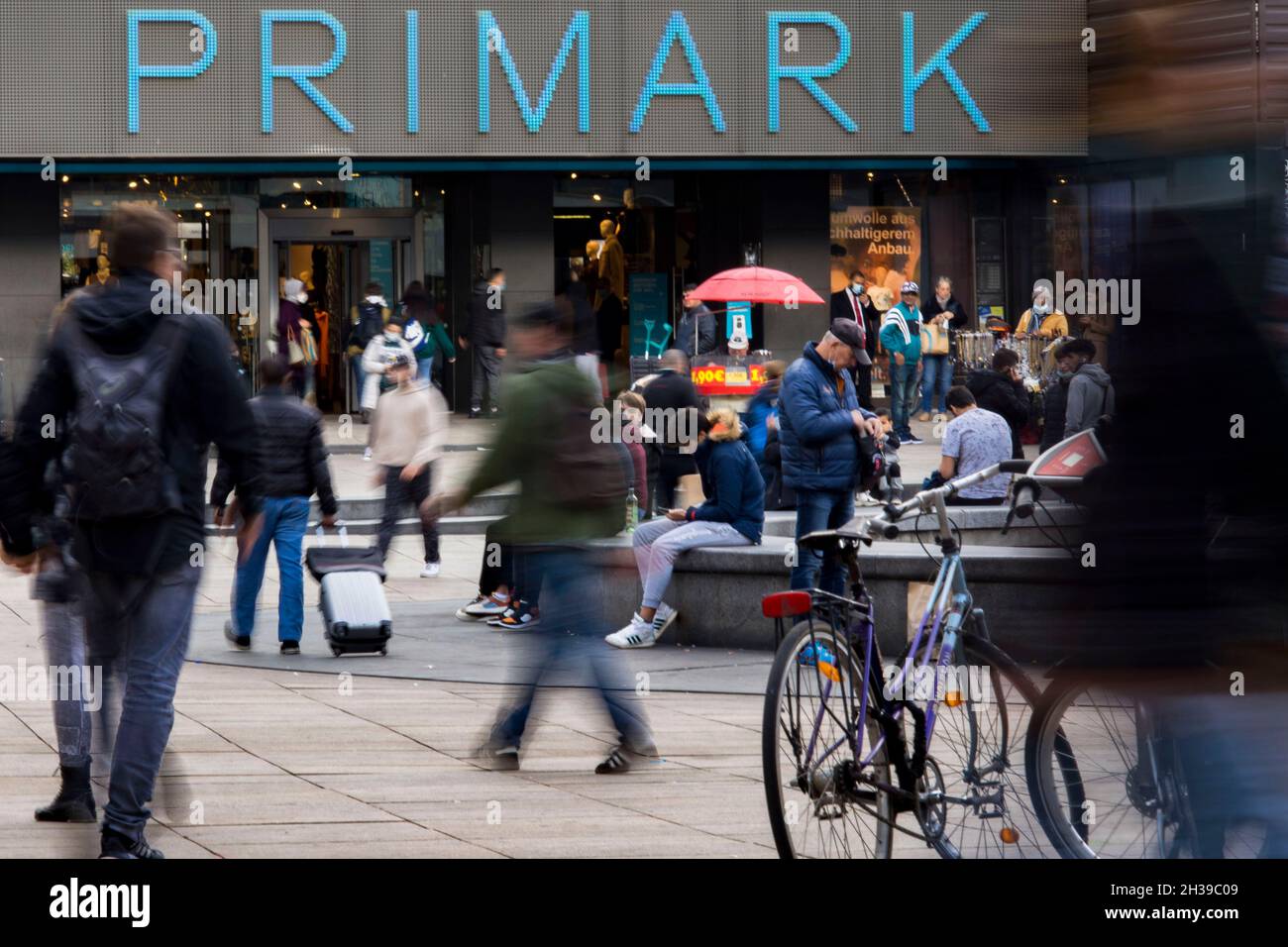 Berlin, Germany. 11th Oct, 2021. Passers-by walk past a store of the ...