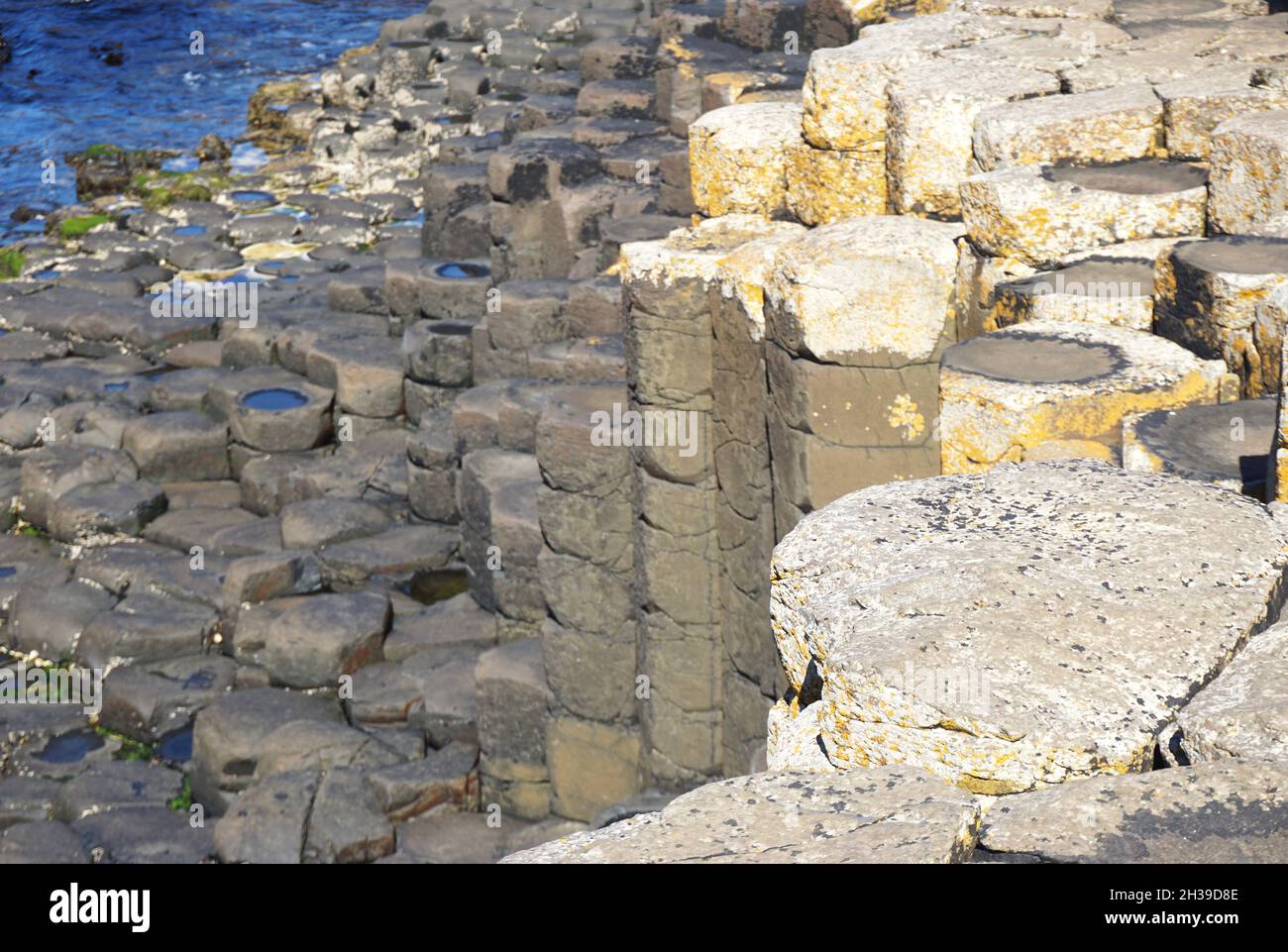 Ancient volcanic basalt pillars with lichen on weathered surfaces at ...