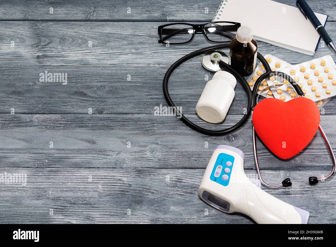 Red heart on the background of pills. Concept of health, heart disease ...