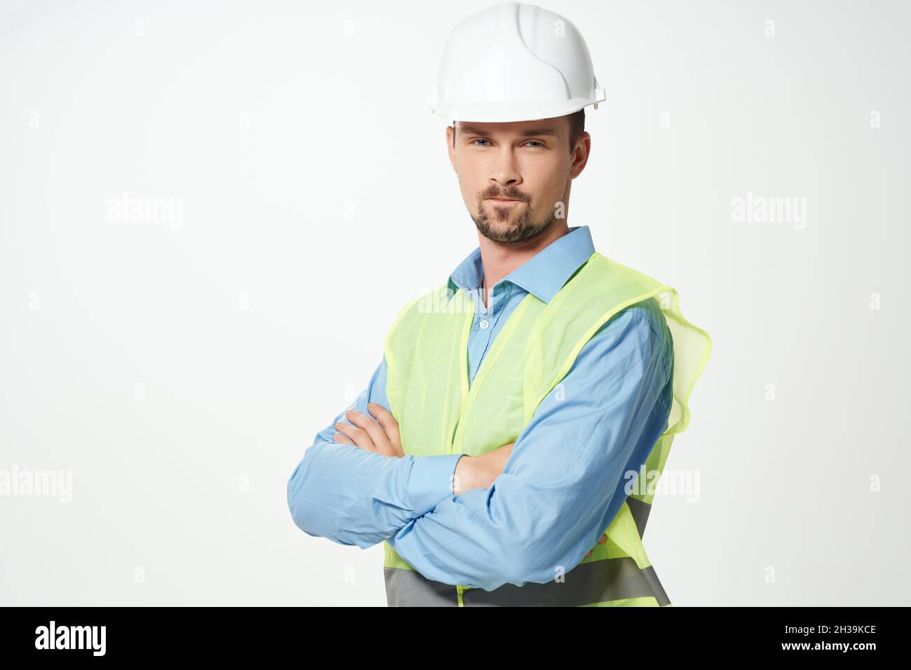 man in construction uniform white helmet safety studio Stock Photo - Alamy