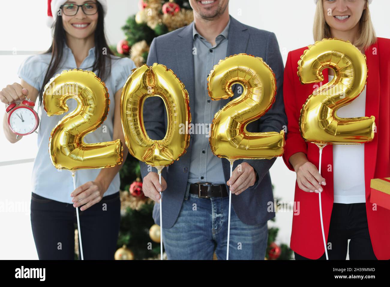 Group of business people holding golden helium balloons with numbers ...