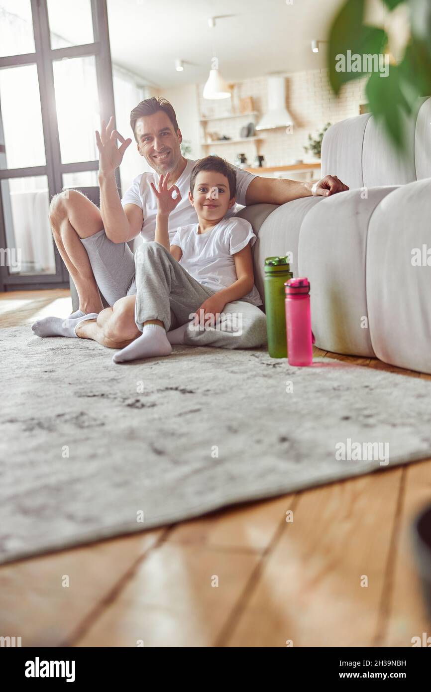 Joyful father and son having good time together at home Stock Photo - Alamy