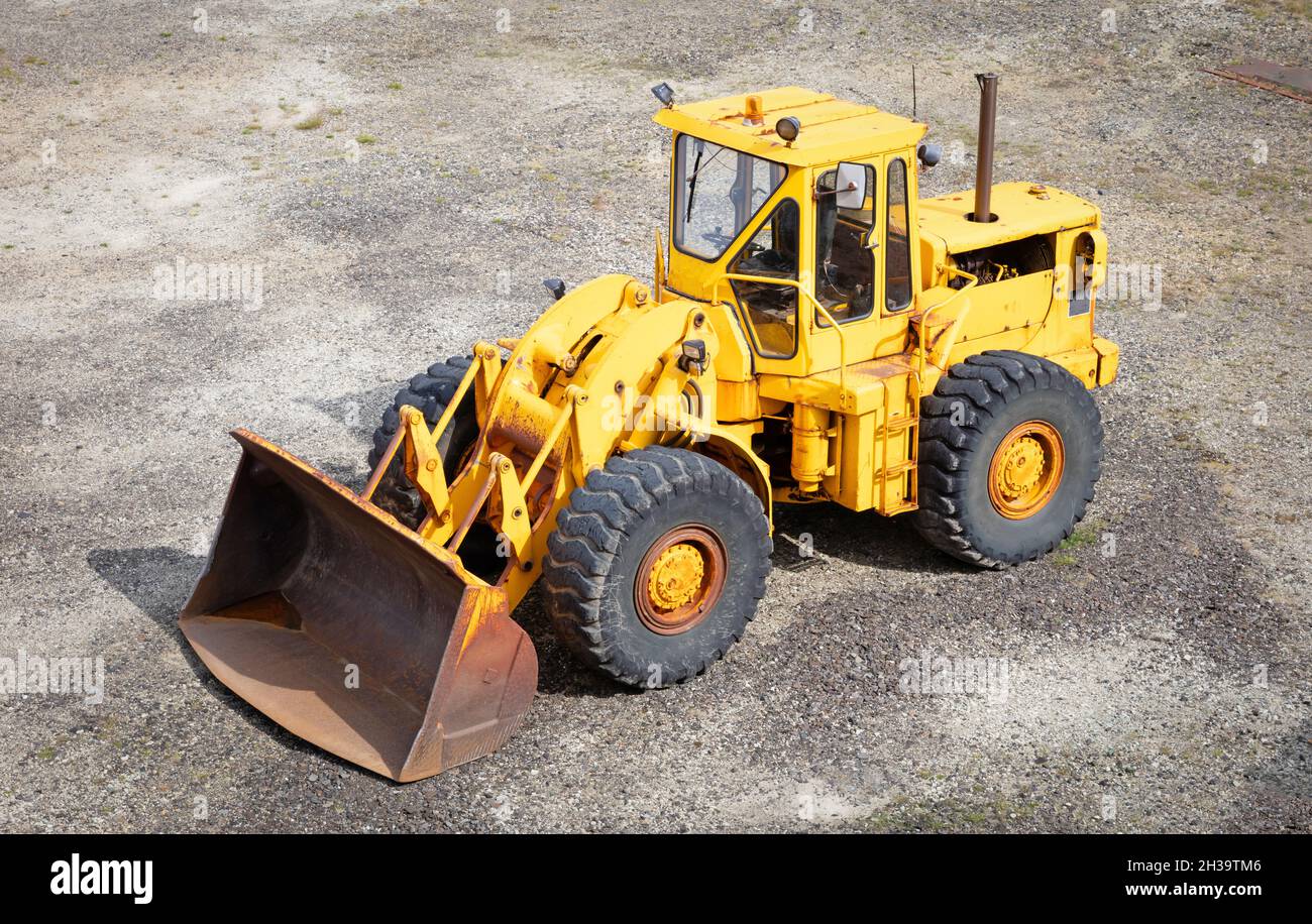 Wheel loader bulldozer with bucket standing in sandpit outdoors ...