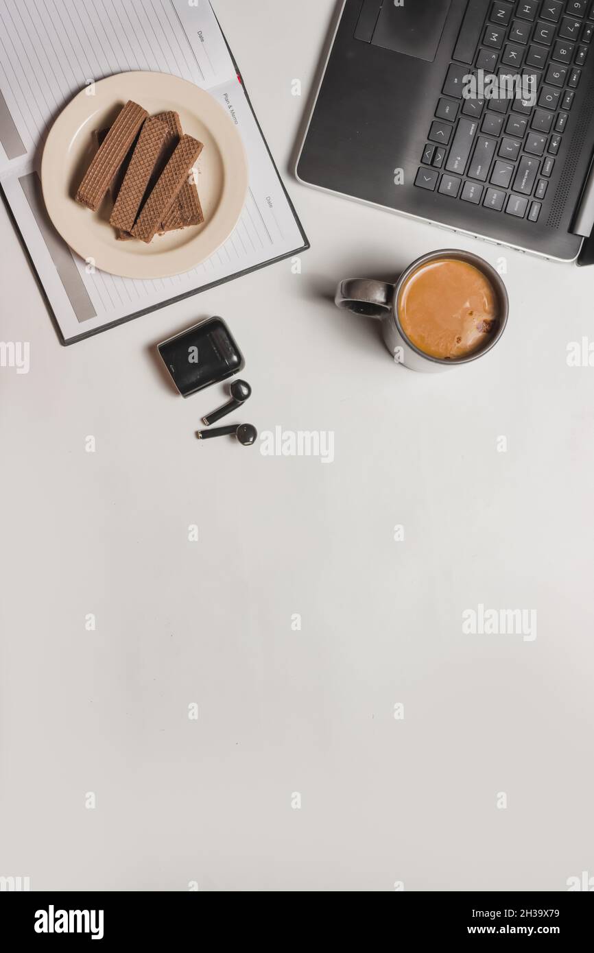 flat lay, coffee, wafer, and laptop, vertical, in white background ...