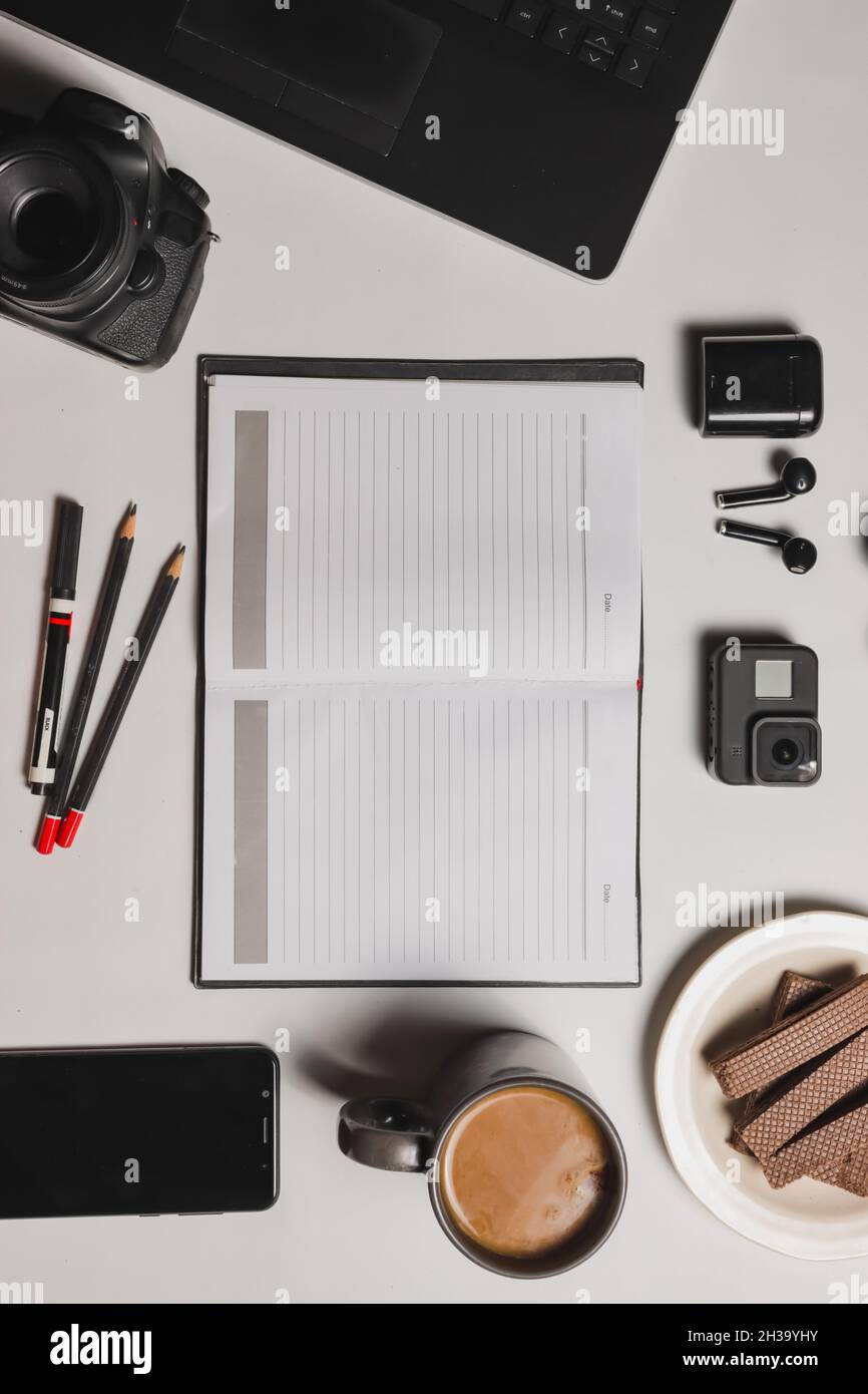 flat lay, books are in the middle with coffee and gadgets, to be ...