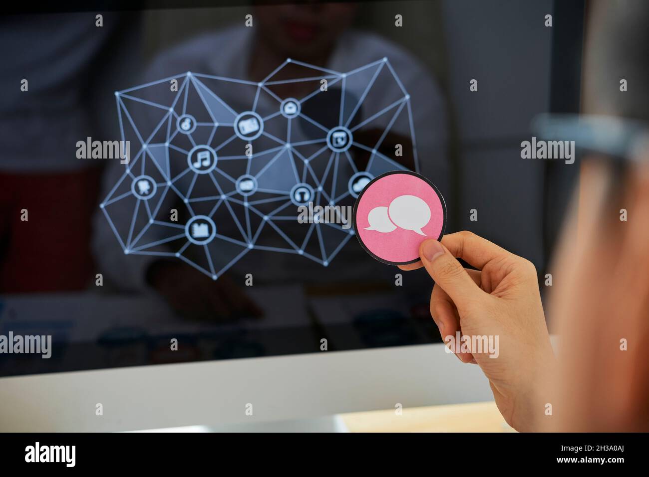 Conversation icon in hand of UI designer working on interface for new ...