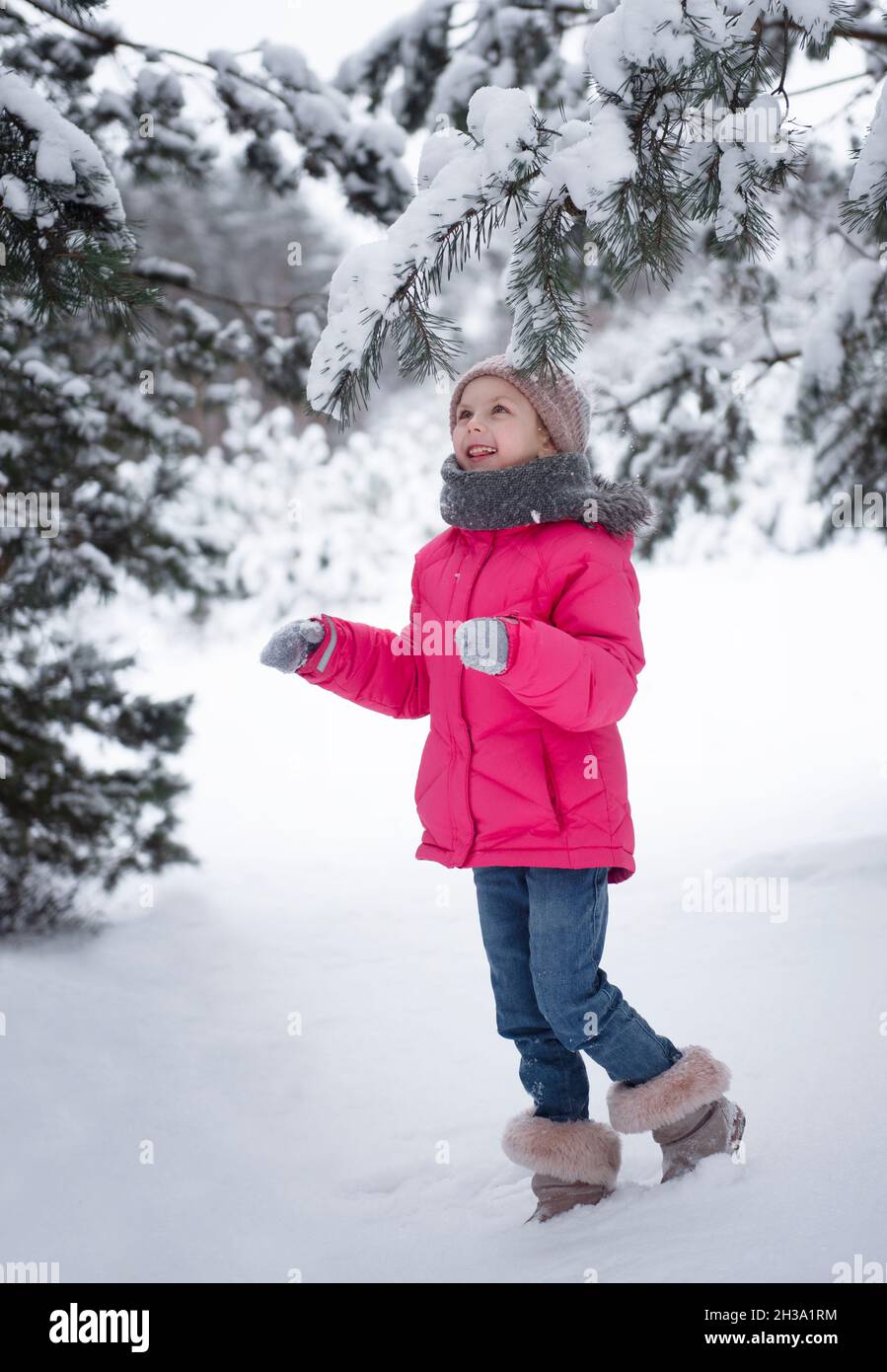 Child in winter. A little girl, playing in the winter outside. A ...