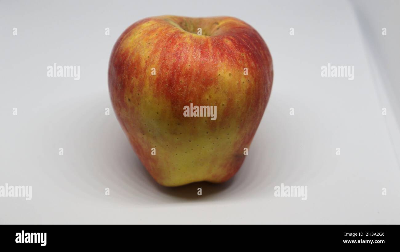 The light red apple is on a white background Stock Photo - Alamy