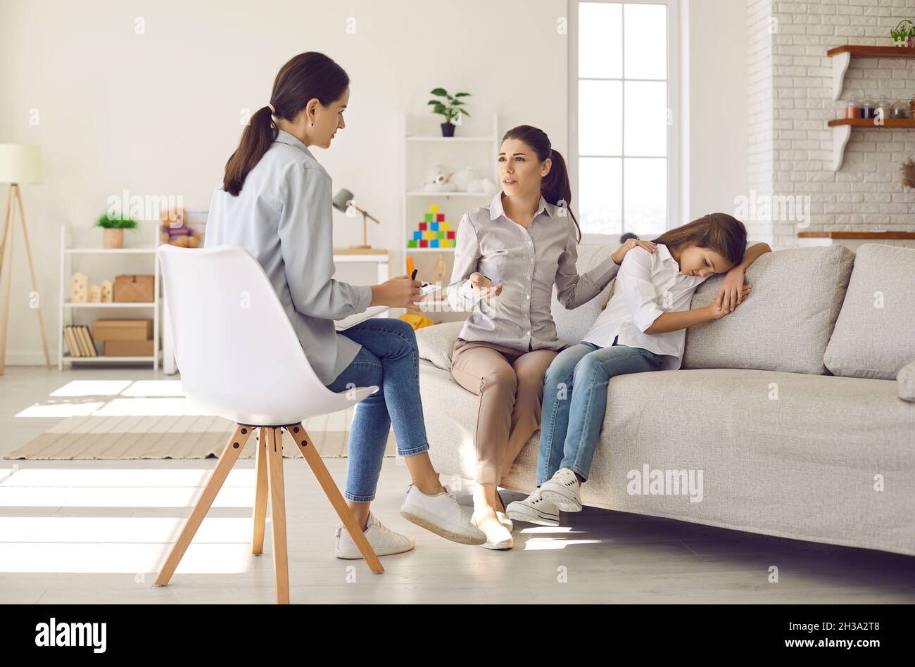 Worried parent having conversation with psychologist about child's ...