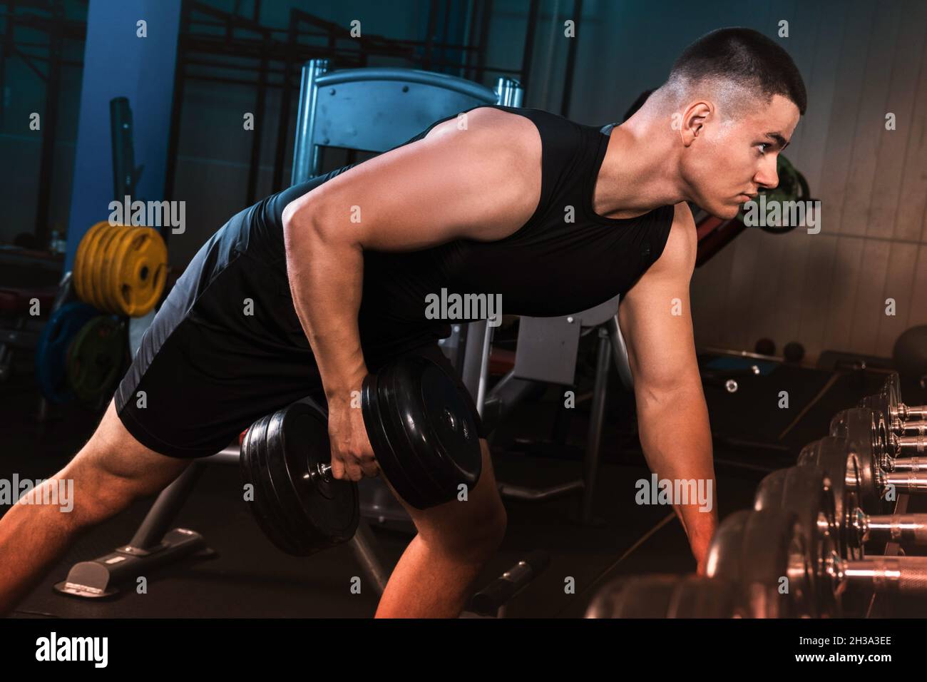 A young guy works out in the gym Stock Photo - Alamy