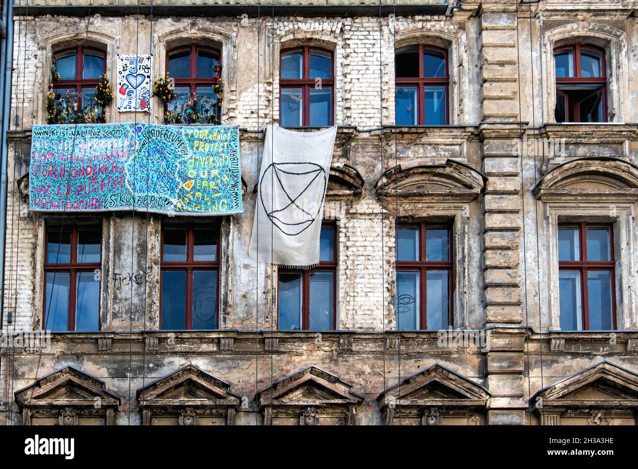 Banners on dilapidated, weathered old apartment building in ...