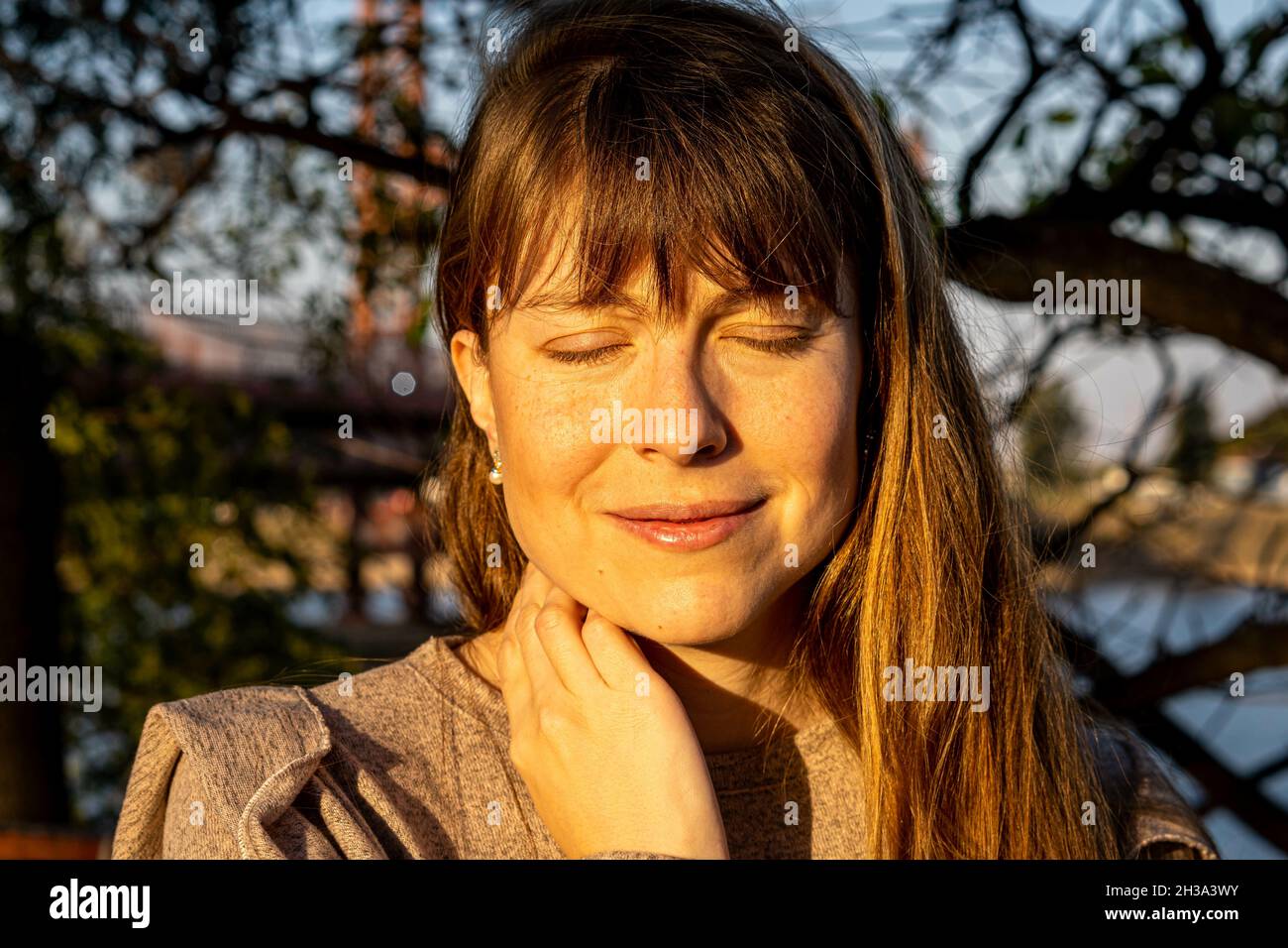 Middle-aged Argentine lady smiling with her eyes closed in the sun ...