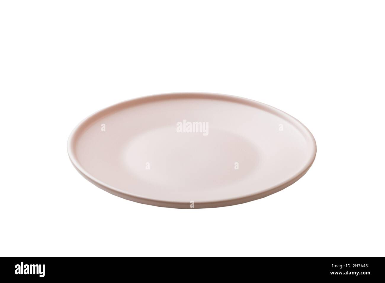 Pink ceramic round plate isolated over white background. perspective ...