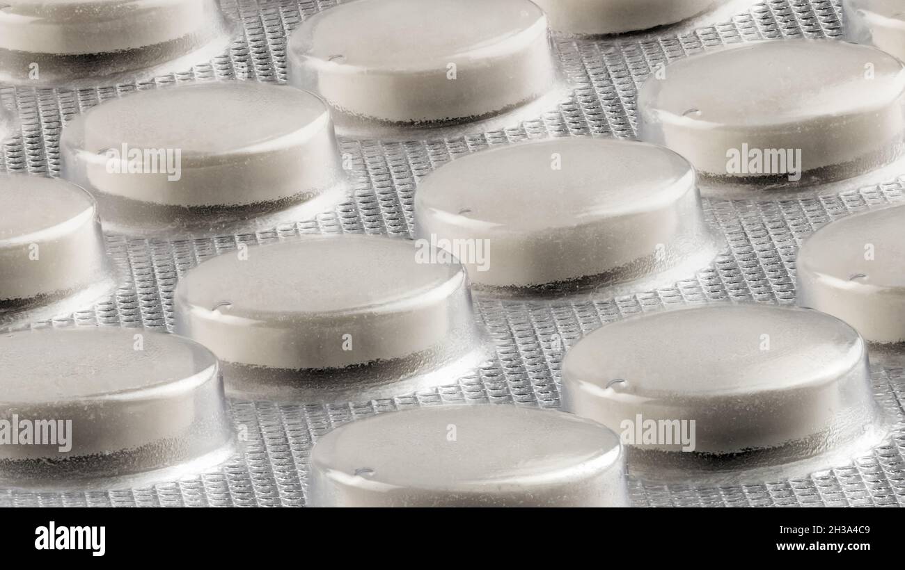 generic white medical tablets in silver foil blister Stock Photo - Alamy