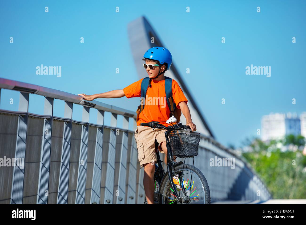 Cute boy hold handrail of bridge sit on bicycle Stock Photo - Alamy