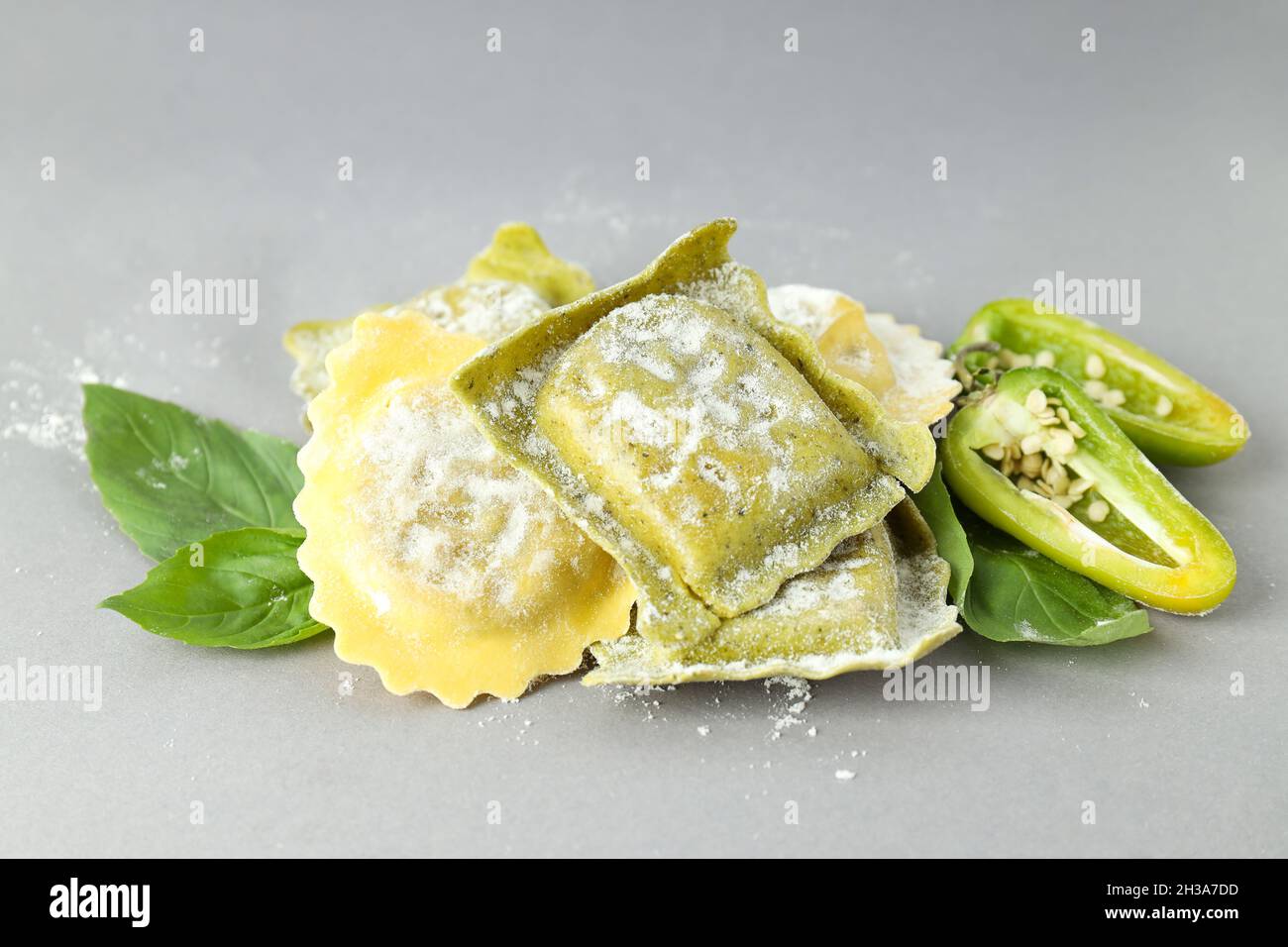 Raw ravioli with spices on light gray background Stock Photo - Alamy