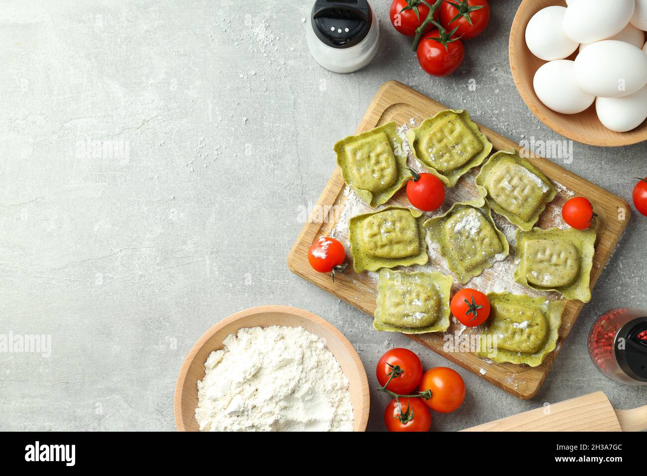 Concept of cooking ravioli on gray textured background Stock Photo - Alamy