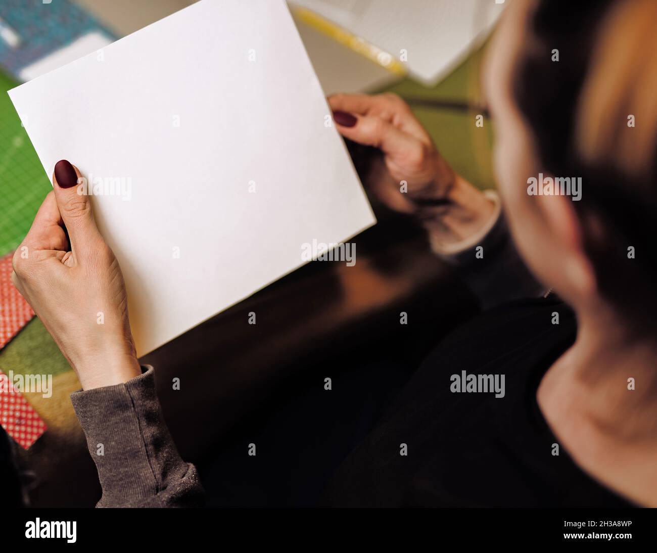 blank white paper sheet in female hands close-up. template for your ...