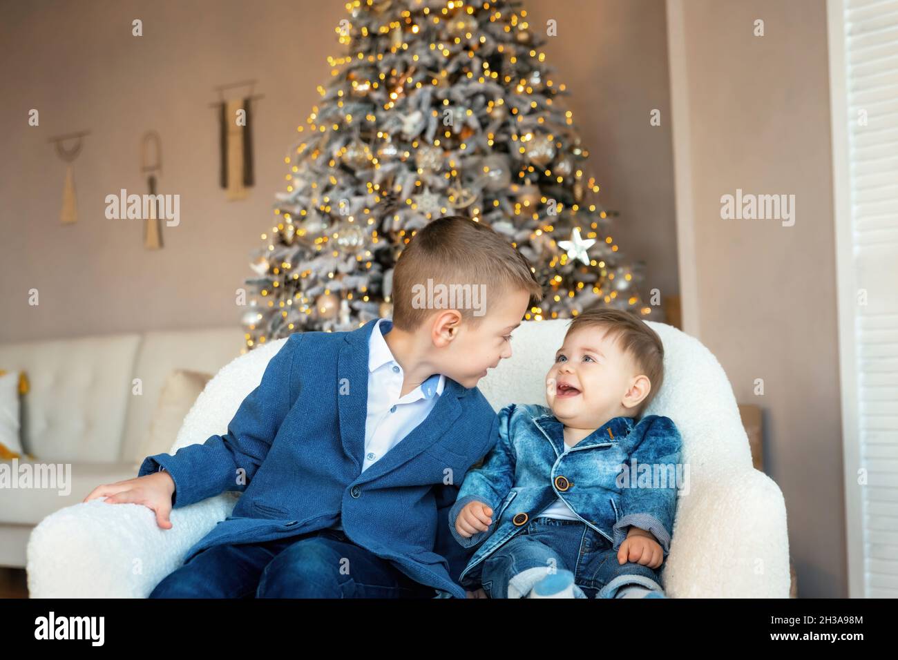 Happy laughing little children. Loving brothers in high spirits looking ...