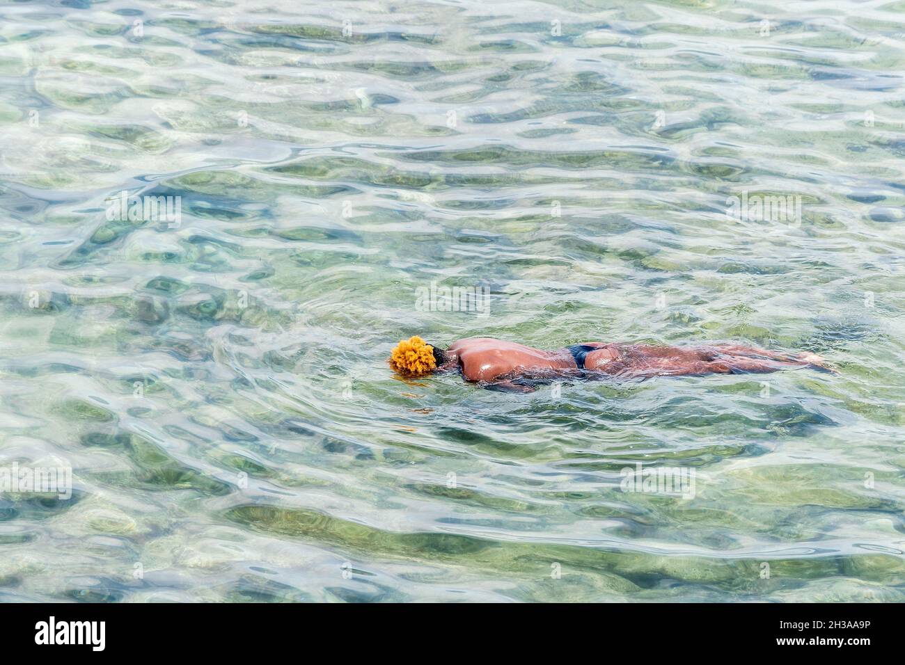 Black man is swiming in the turquoise sea water Stock Photo - Alamy