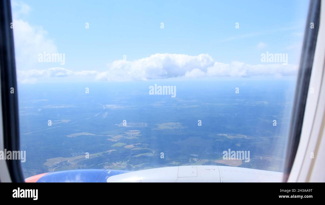 Clouds and sky as seen through window of an aircraft. Concept flying ...