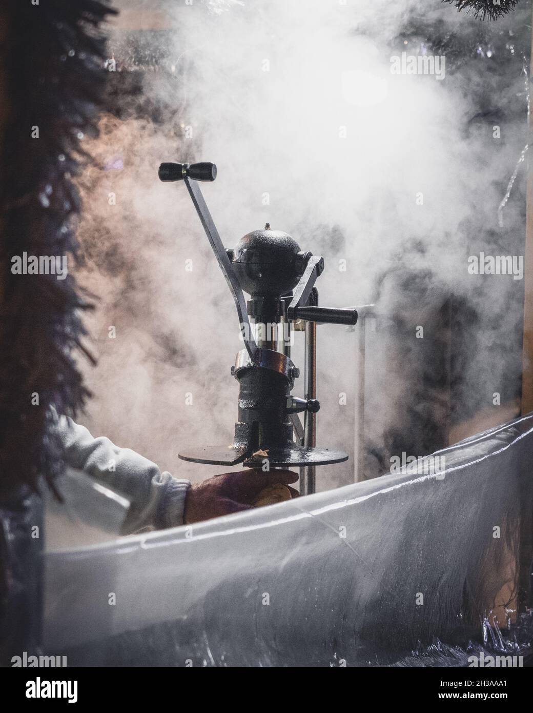 Male hands making churros with brand new hand-operated churros machine ...