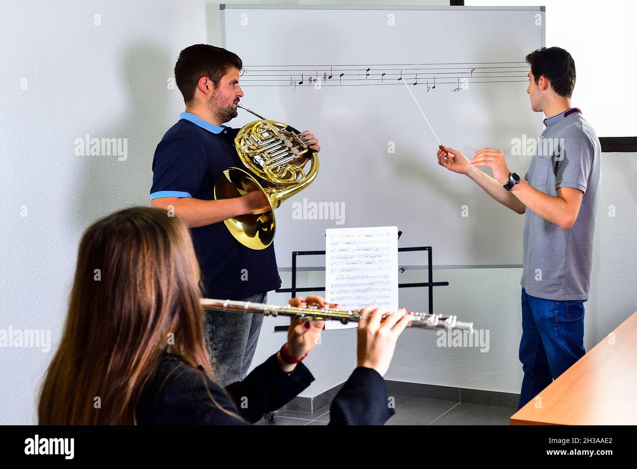 Music conservatory teacher, corrects the lesson in the classroom Stock ...